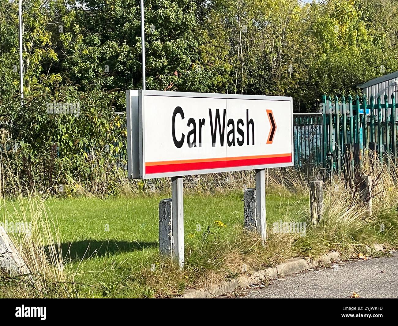 car wash facility with signage on a sunny day. The setting is ...
