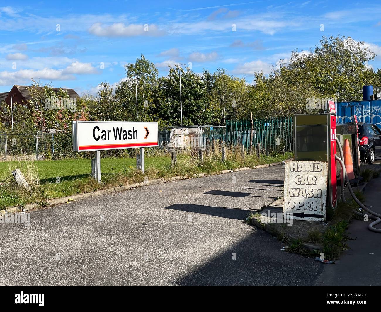 car wash facility with signage on a sunny day. The setting is ...