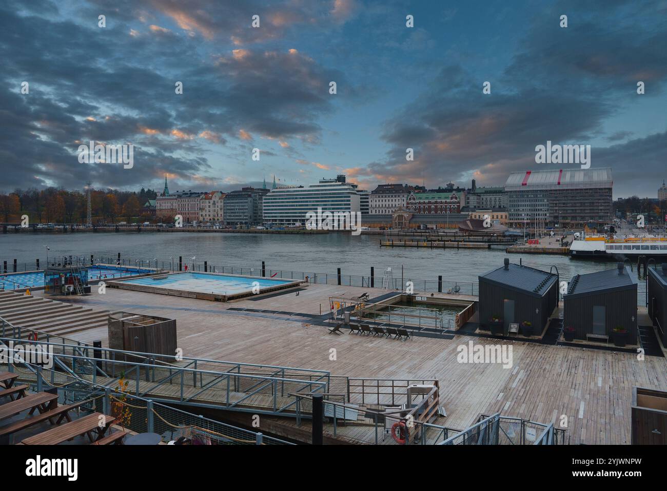 View of Helsinki's waterfront featuring a wooden deck, small structures ...