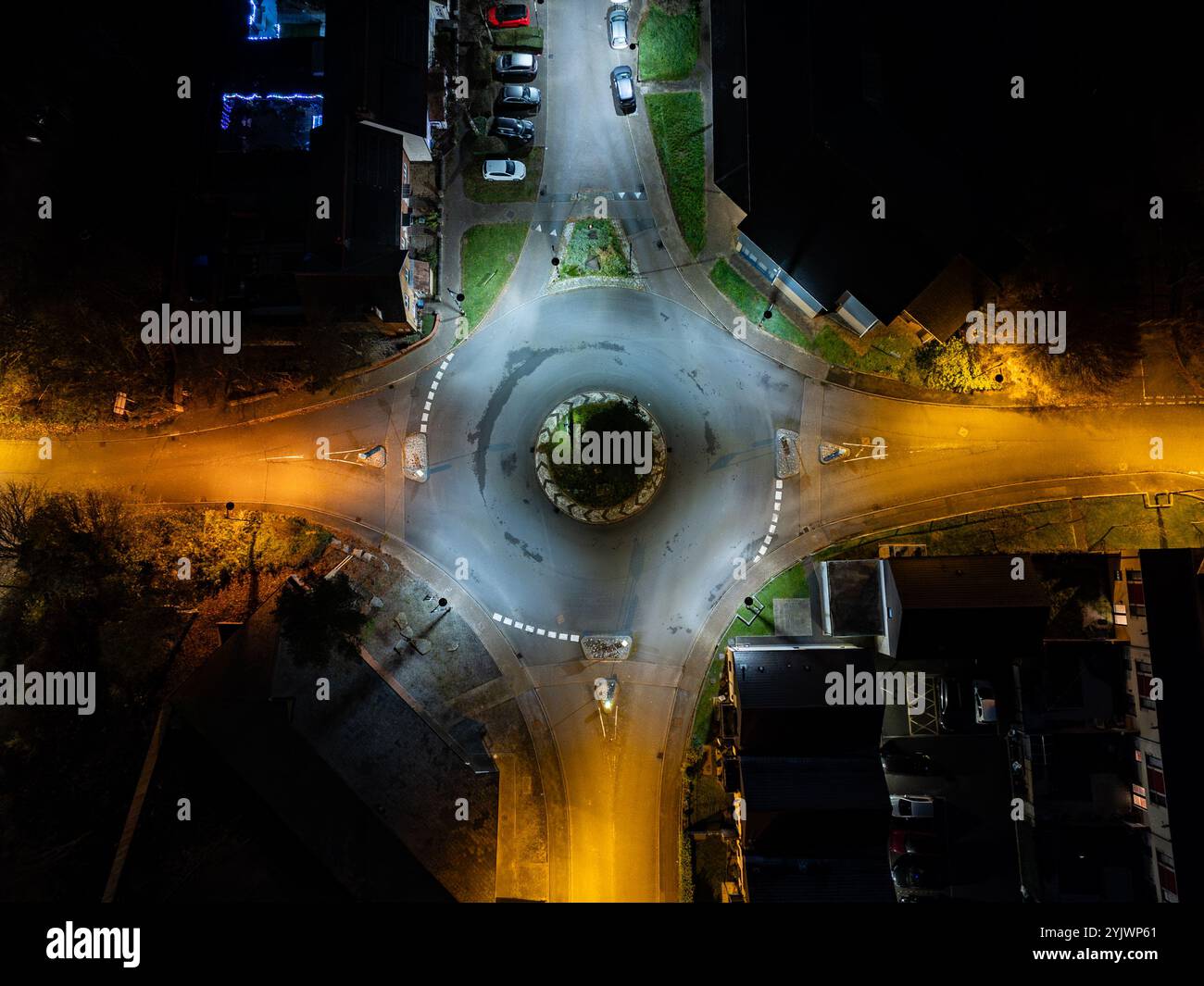 Aerial view of a brightly lit roundabout at night, guiding traffic ...