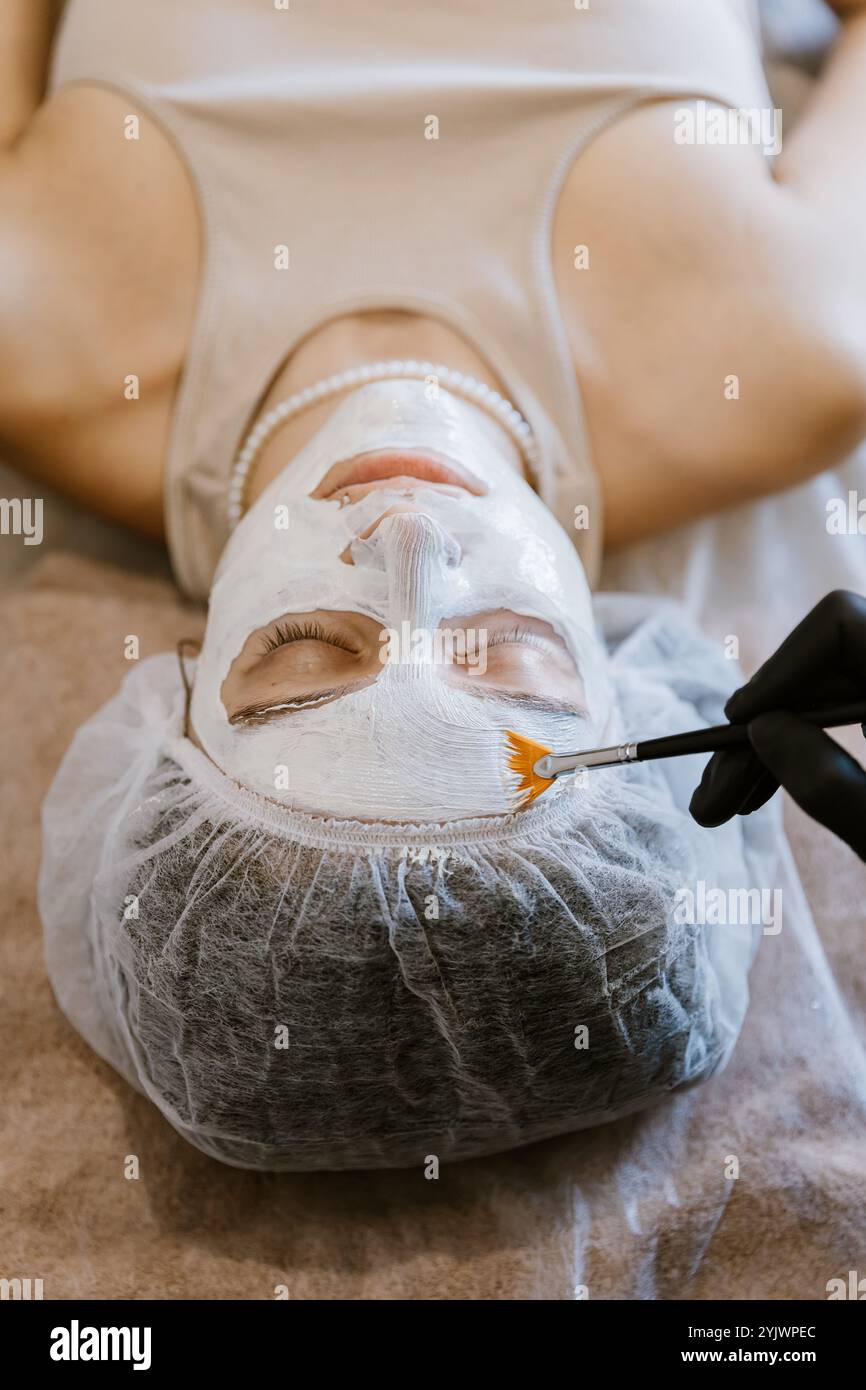 Luxury facial treatment with clay mask application for glowing, rejuvenated skin at a spa Stock ...