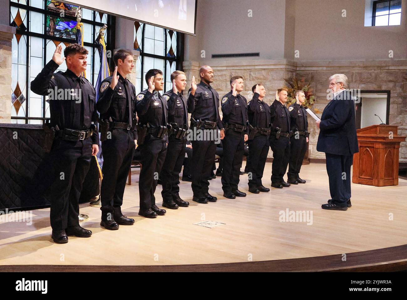 Owensboro, Ky., Mayor Tom Watson swears in the nine police recruits of Class #1 by giving the ...