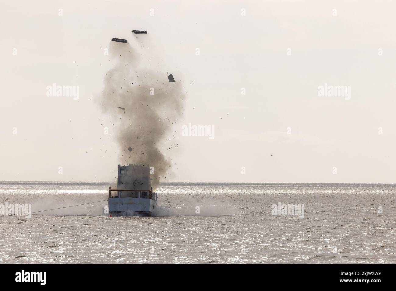 Explosives are detonated inside SEA DOG, a retired U.S. Navy vessel ...