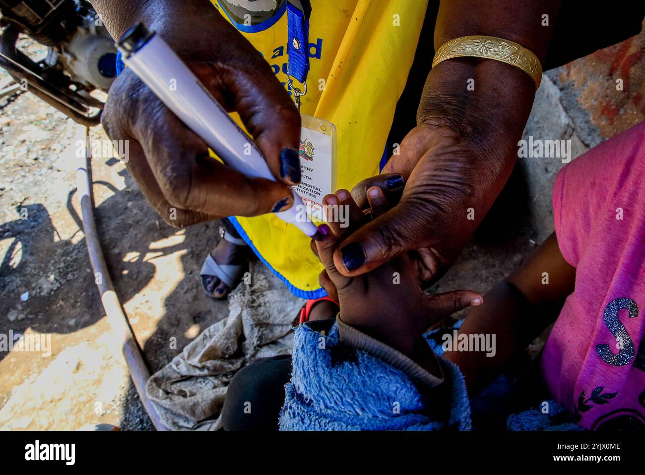 A community health worker seen marking a Childs finger after an oral ...