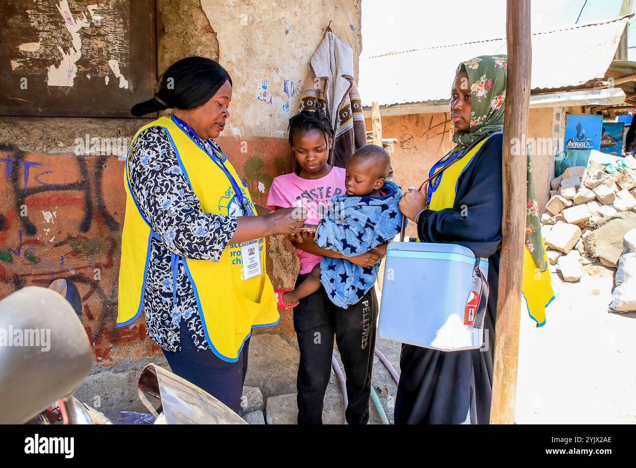 A Community health worker is marking a Childs finger after an oral ...