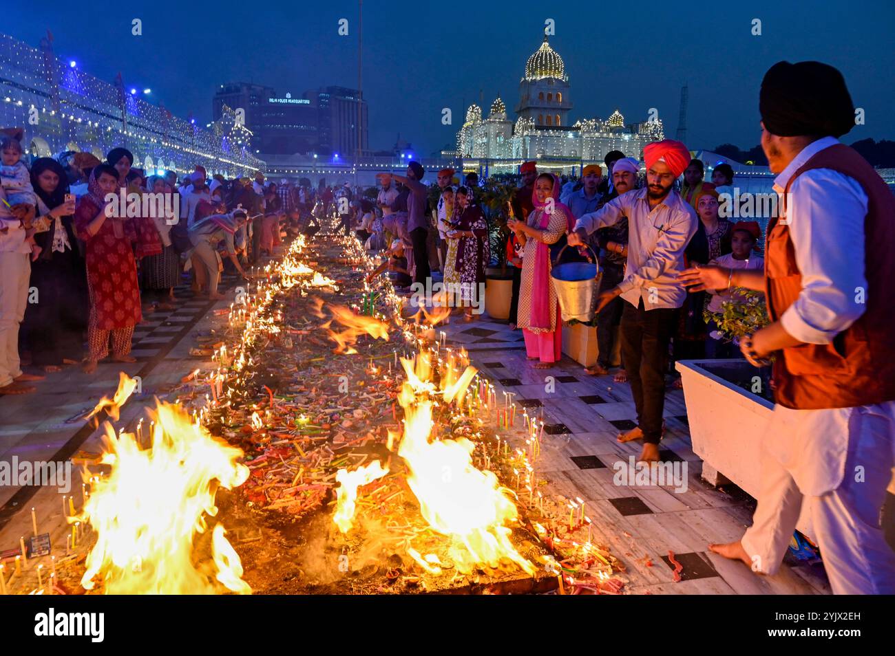 NEW DELHI, INDIA - NOVEMBER 15: Devotees seen lighting the candles on the occasion of 555th Guru ...