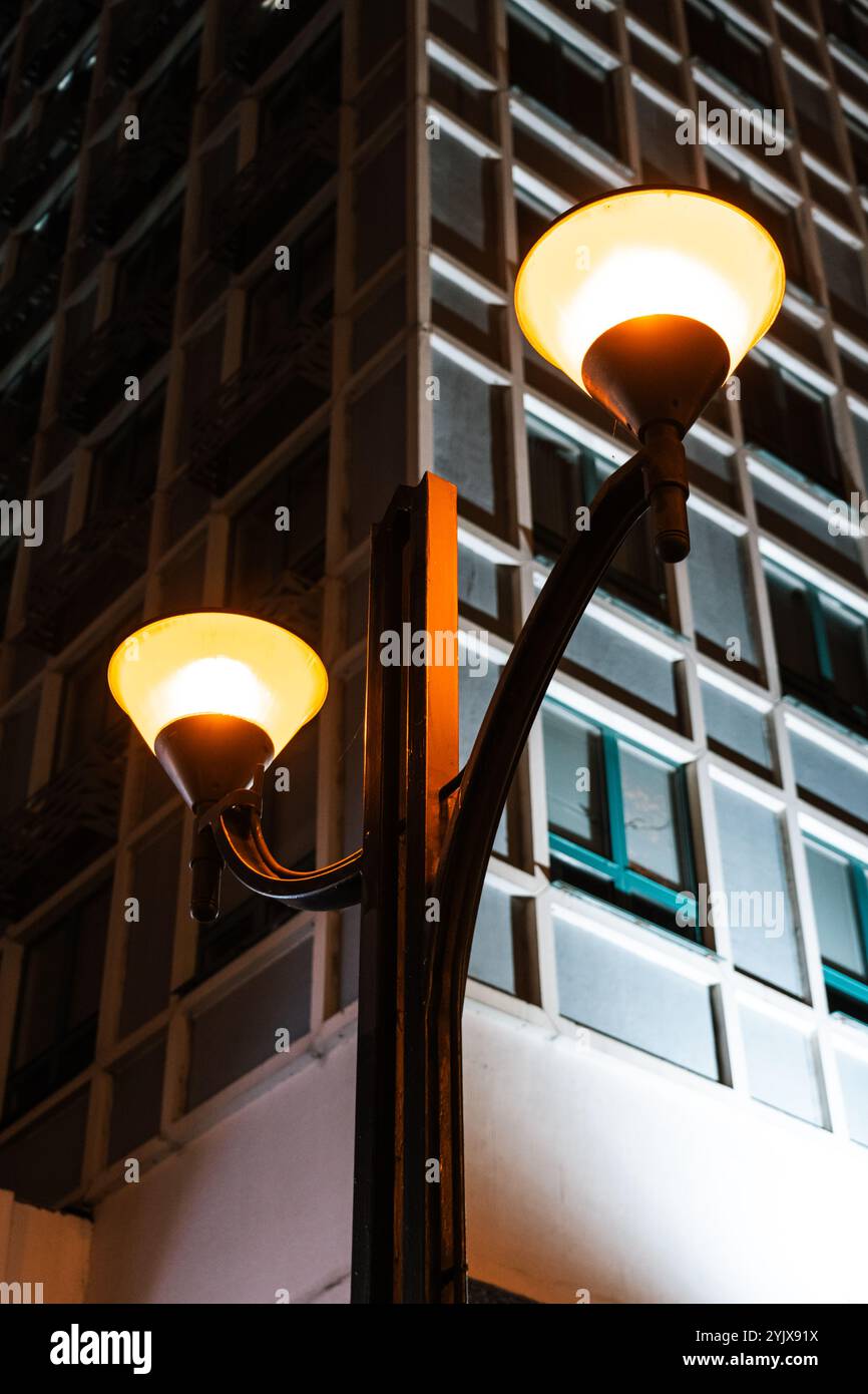 Orange, vintage street lights overlooking a tall building in Minsk at ...