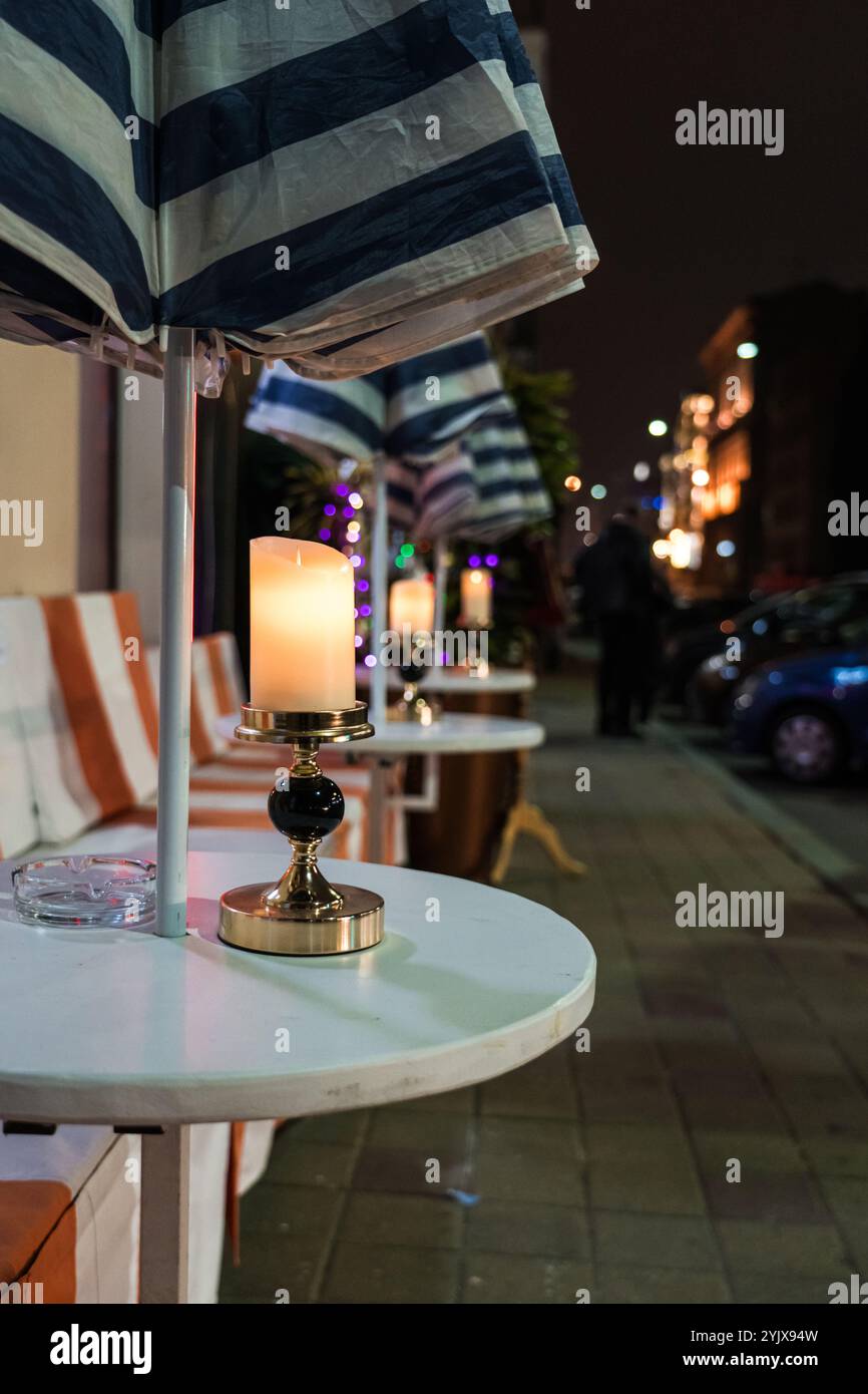 Tables of an outdoor restaurant. The candle is on the table. Minsk ...