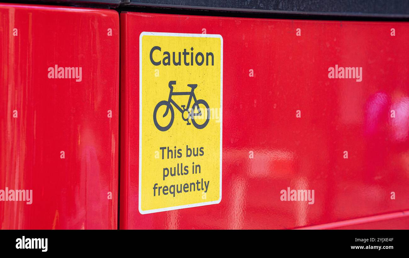 warning sign of bicycles approaching buses, "caution this bus pulls in ...