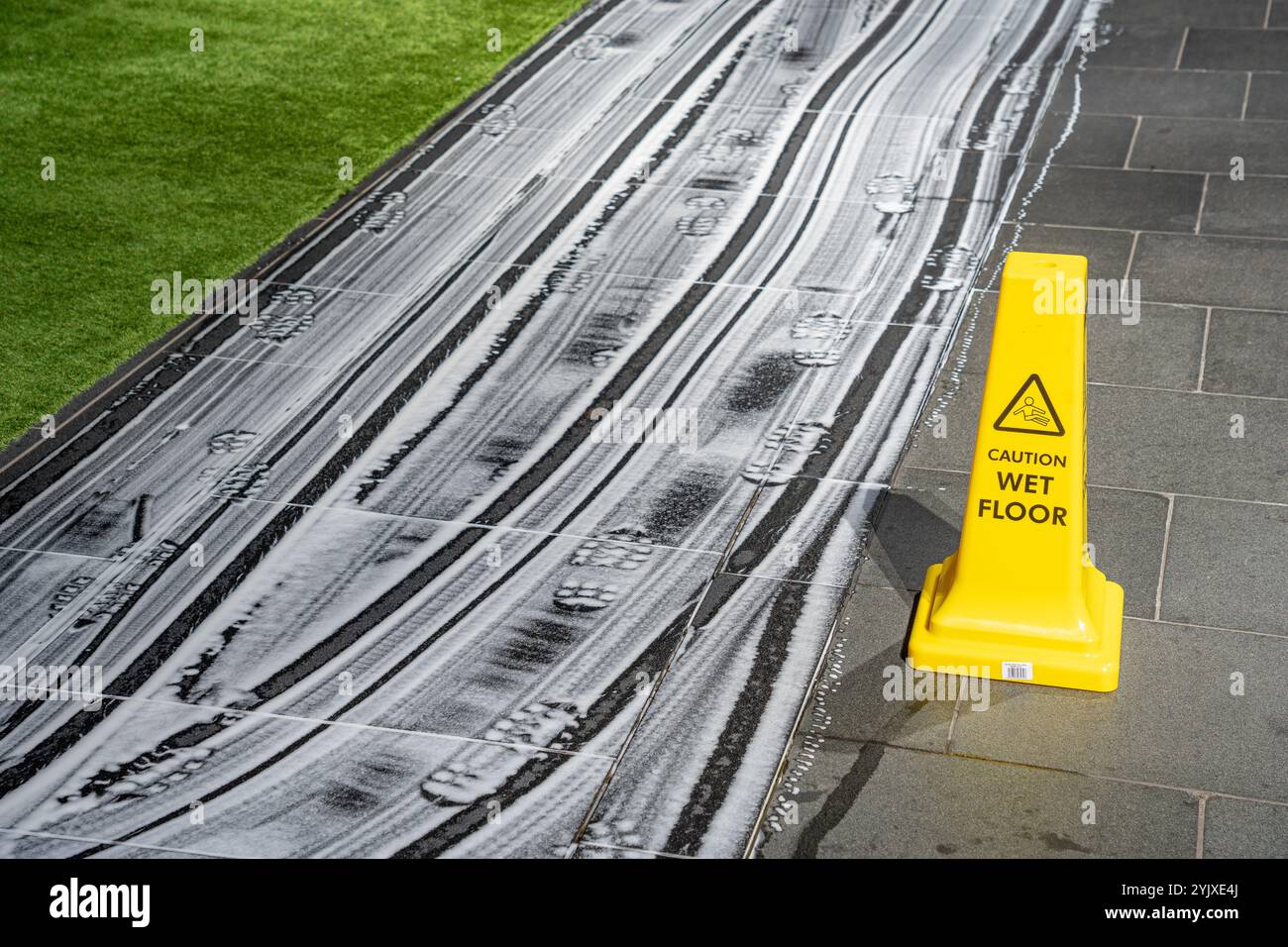 Wet floor danger sign or information element with detergent marks on ...