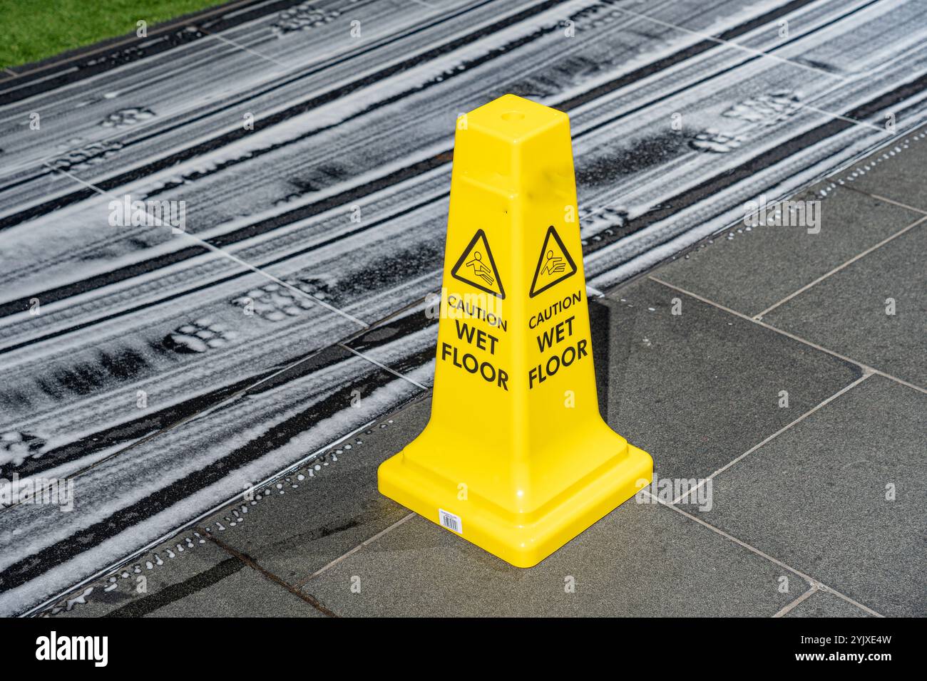 Wet floor danger sign or information element with detergent marks on ...