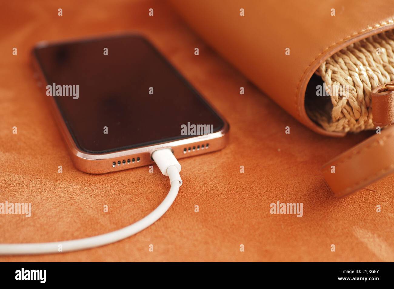 charging smart phone with a cable Stock Photo - Alamy