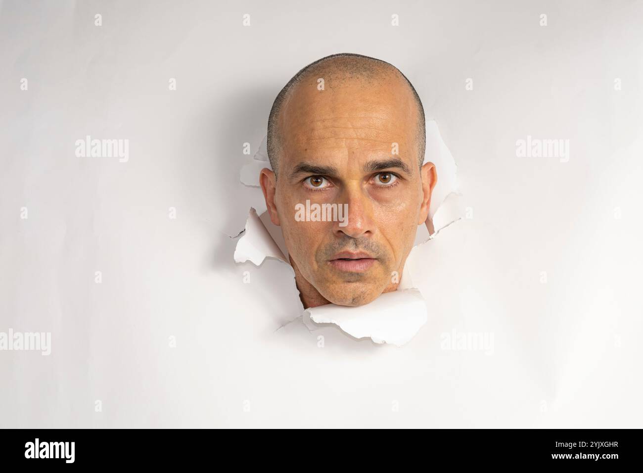 48 year old Brazilian man in casual clothes, only his head on a torn ...