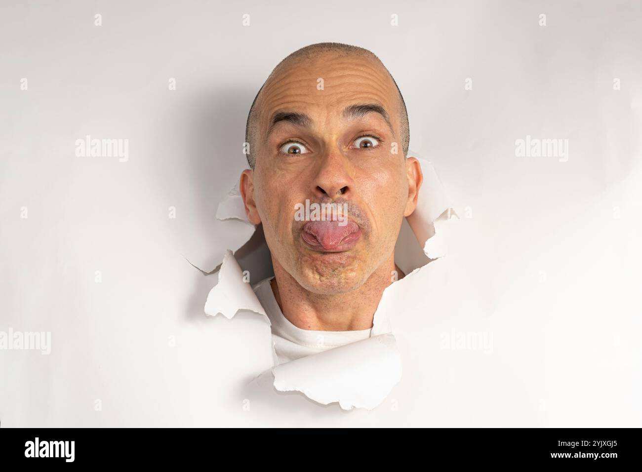 48 year old Brazilian man in casual clothes, only his head on a torn ...