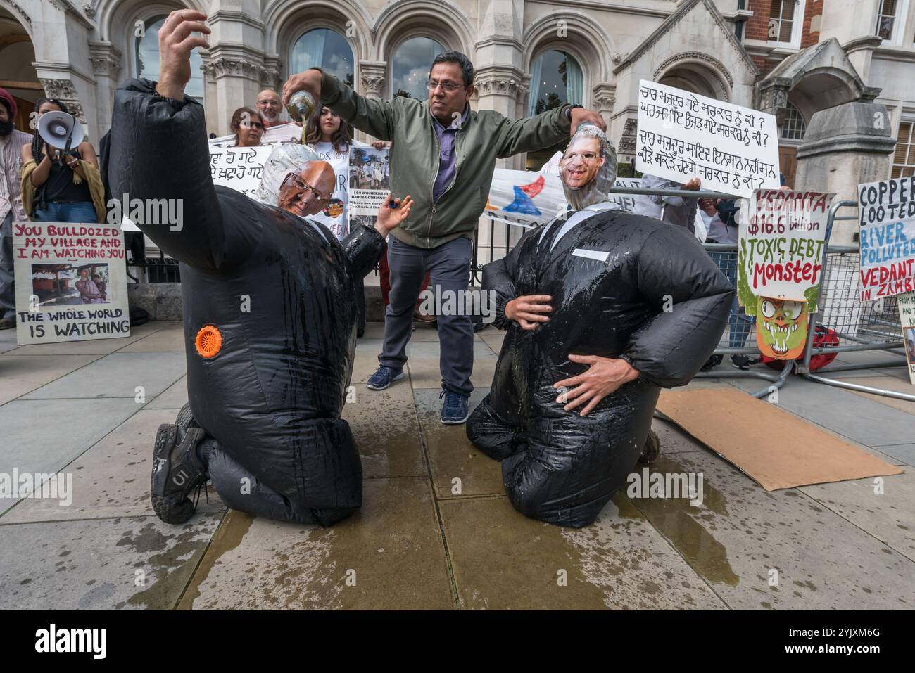London, UK. 14th August 2017. A protester pours the bottles labelled as ...