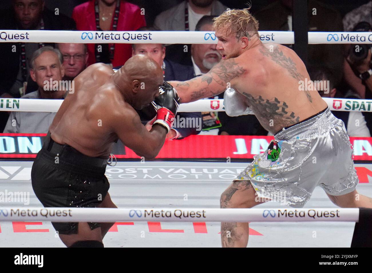 Mike Tyson, left, fights Jake Paul during their heavyweight boxing ...