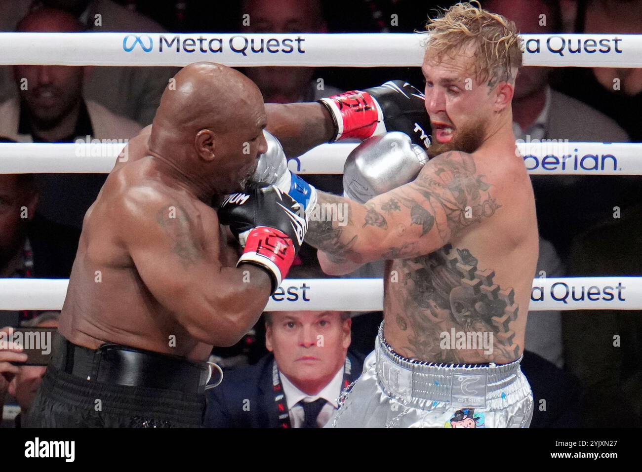 Mike Tyson hits Jake Paul during their heavyweight boxing match, Friday ...