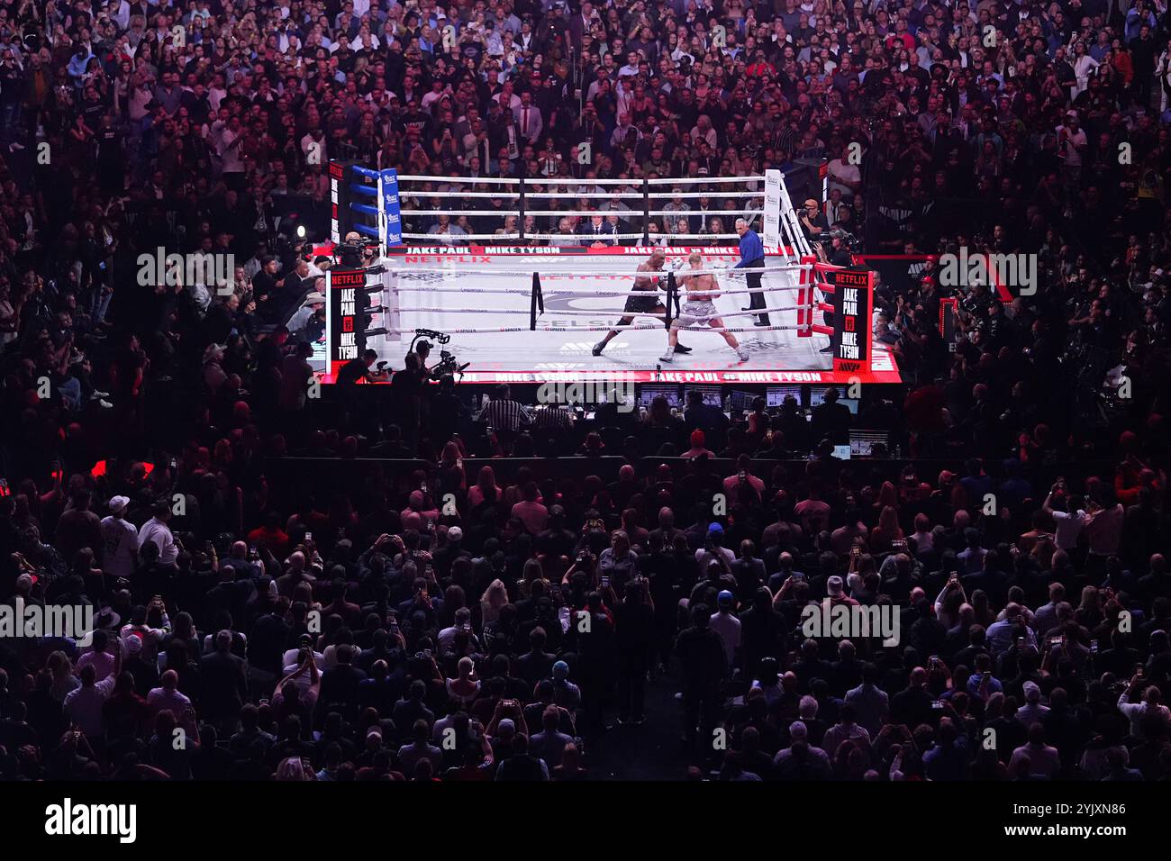 Mike Tyson, left, fights Jake Paul during their heavyweight boxing ...