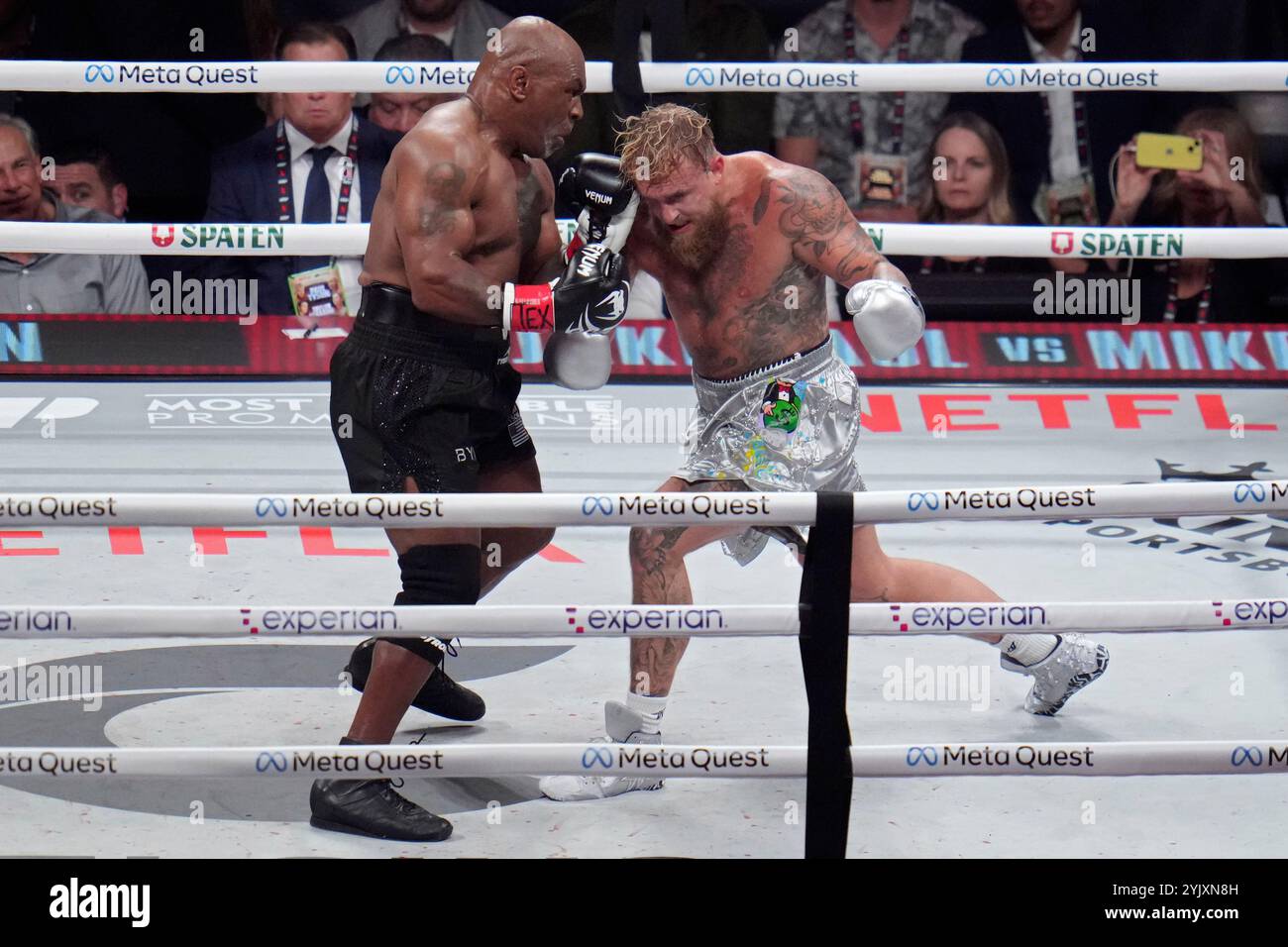 Mike Tyson, left, fights Jake Paul during their heavyweight boxing ...