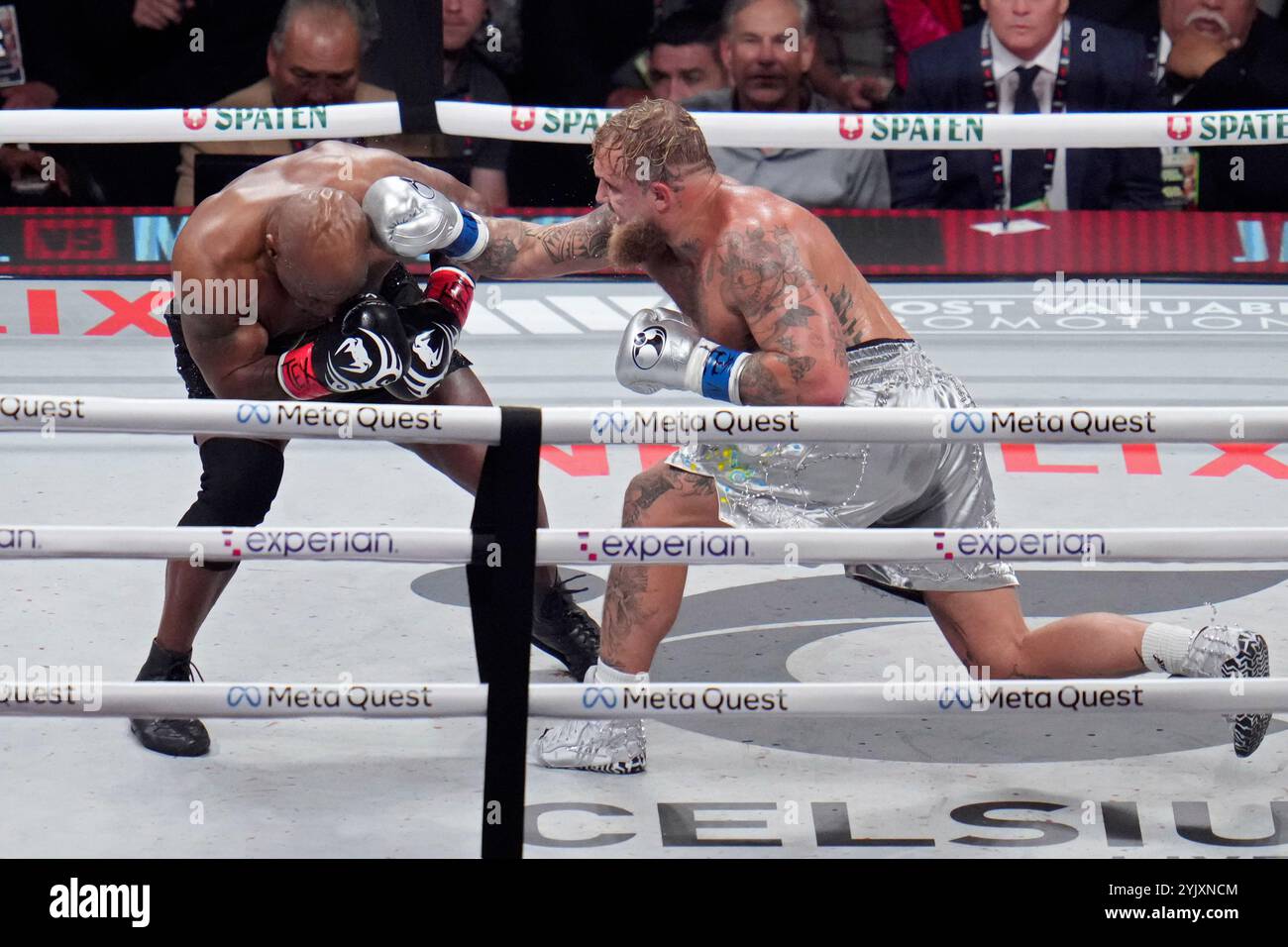 Jake Paul hits Mike Tyson during their heavyweight boxing match, Friday ...