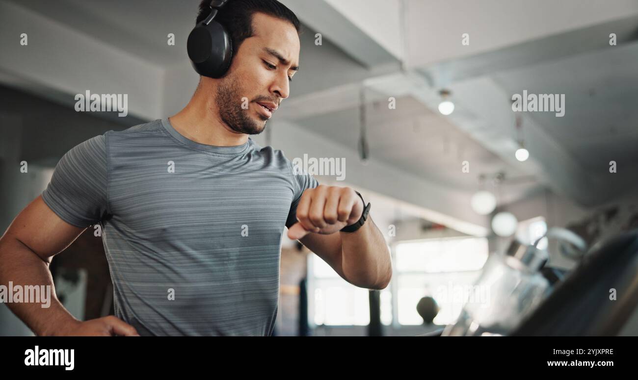 Fitness, gym and man with time, music and heart rate check with ...