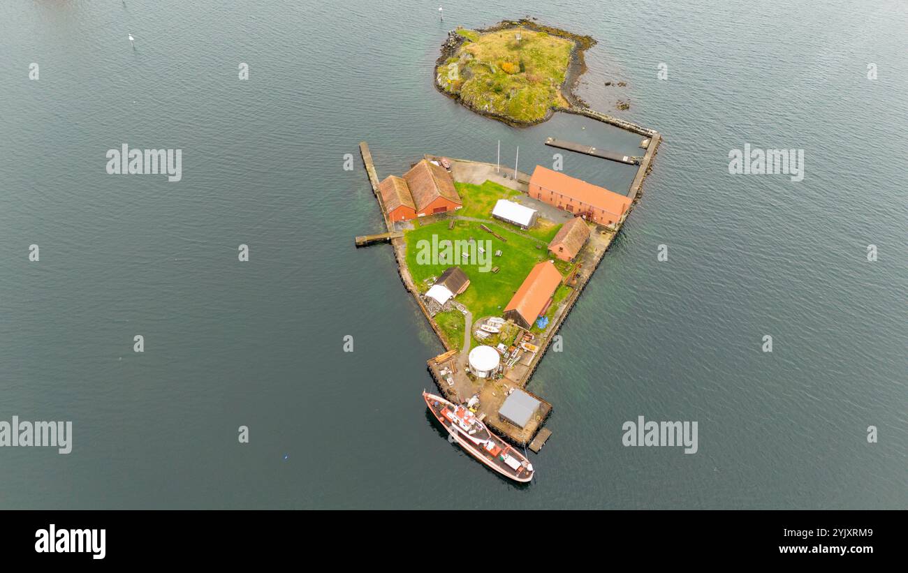 Aerial view of a small triangular island with red-roofed buildings ...