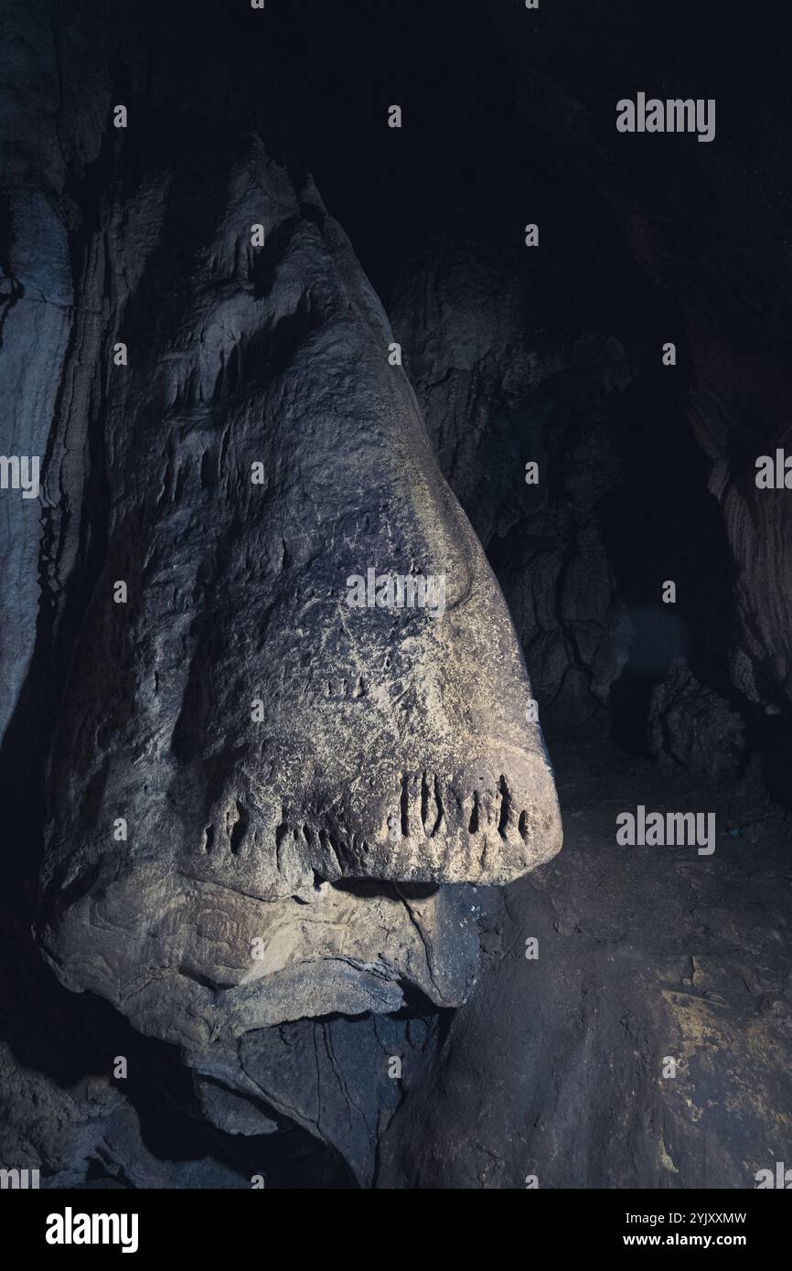 A stone in the Bukit Buntu Kesu Tana Toraja cave is in the shape of a ...