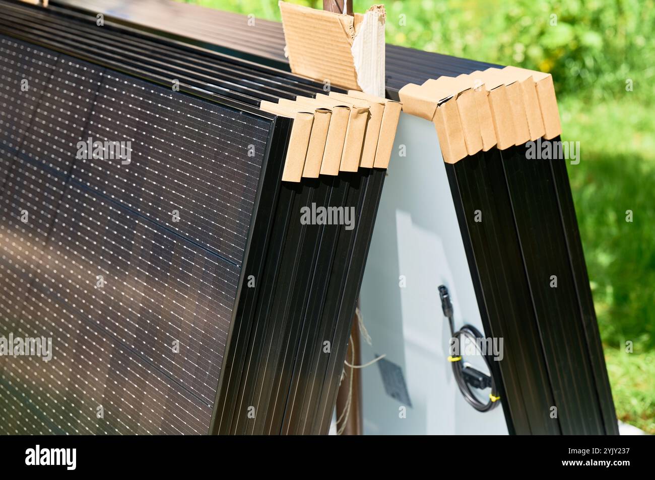 Close-up new solar panels with protective cardboard corners, ready for ...