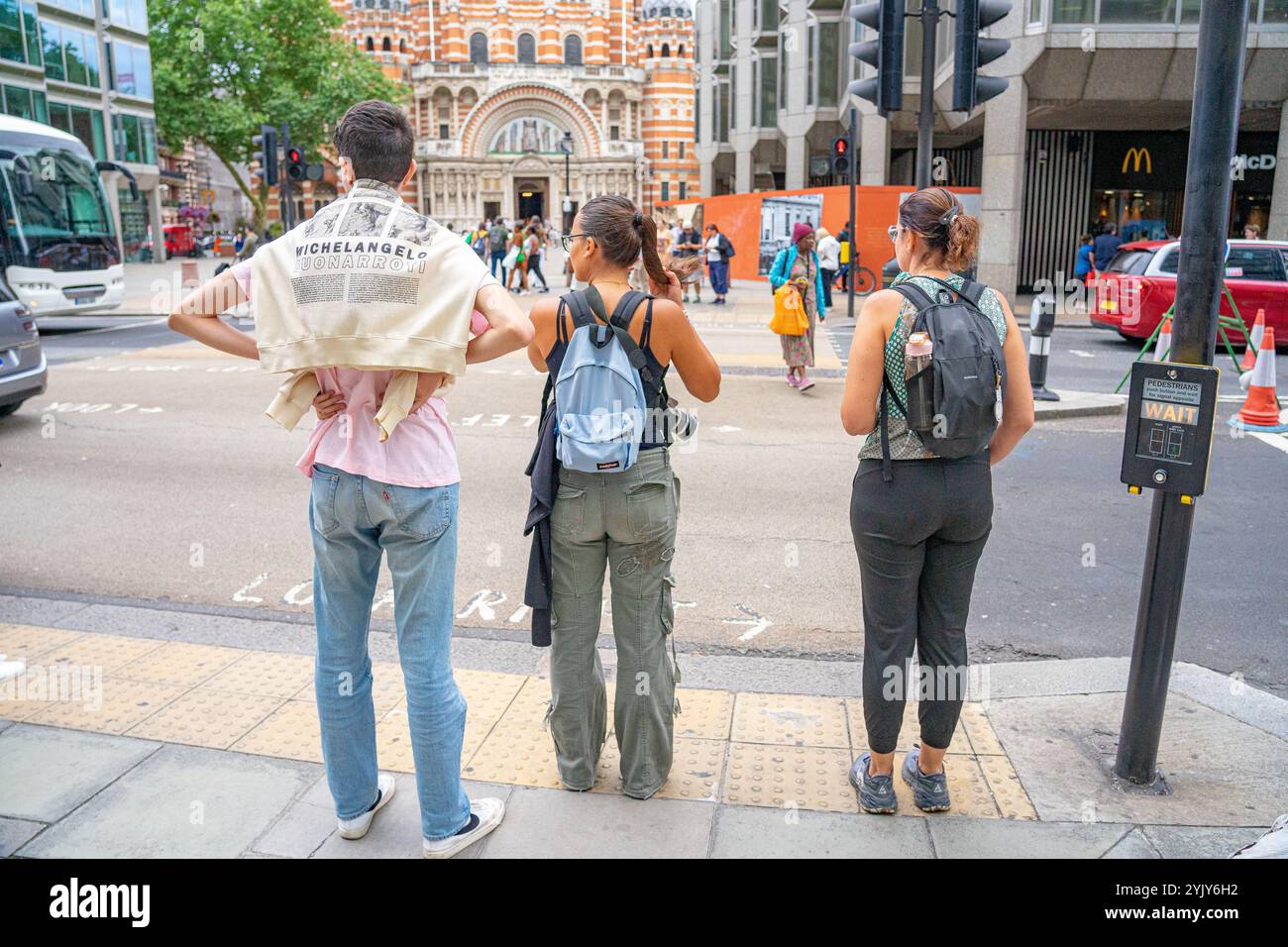 people crossing the road at the pedestrian crossing with traffic ...