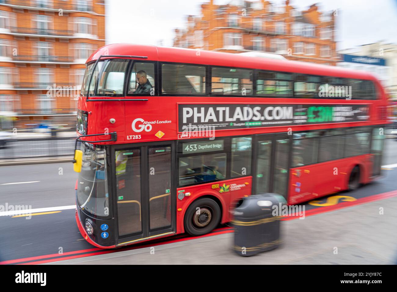British double-decker bus in blurred motion arriving at Baker Street in ...