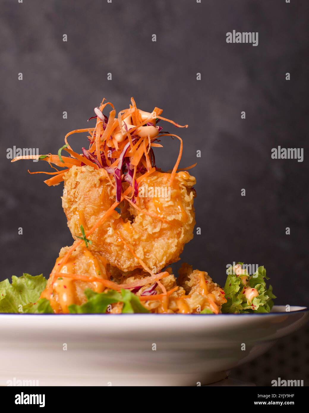 The picture shows crispy fried shrimp, golden on the outside and tender ...