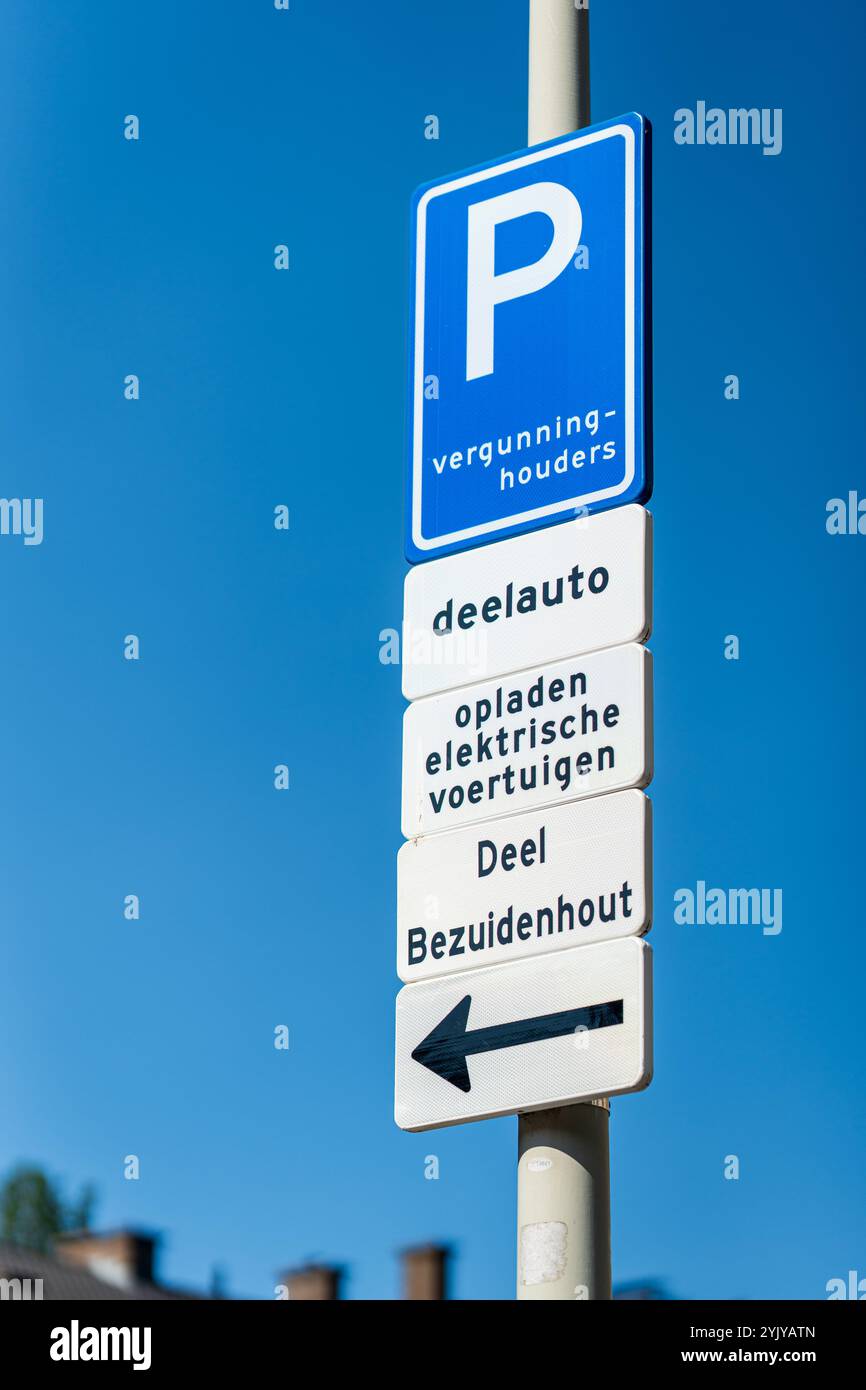 A parking sign designating a spot for car-sharing vehicles. Promoting ...