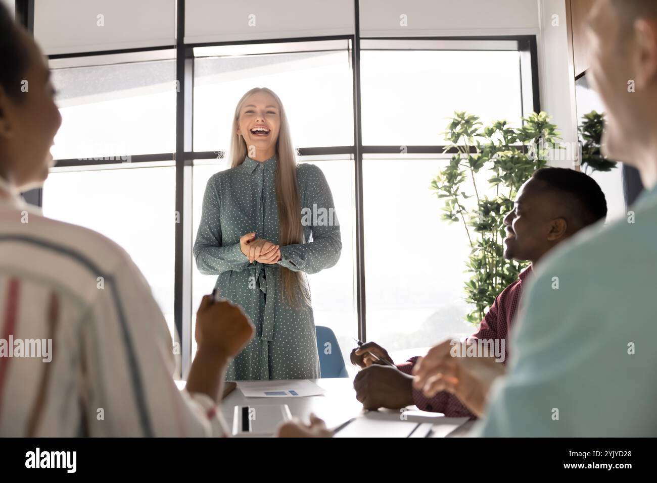 Cheerful young reporter woman speaking at business meeting Stock Photo ...