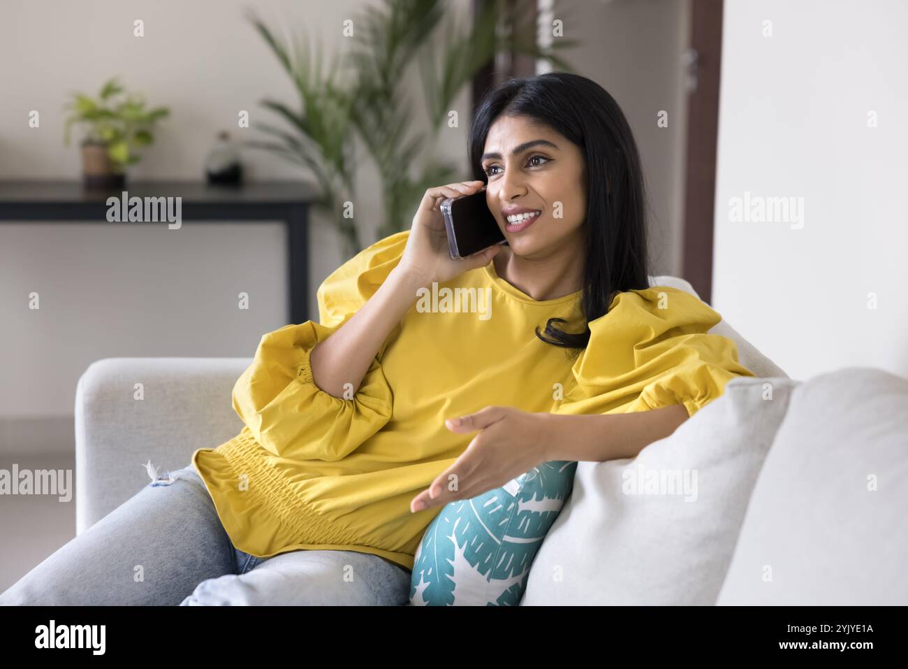 Positive beautiful Indian woman making telephone call Stock Photo - Alamy