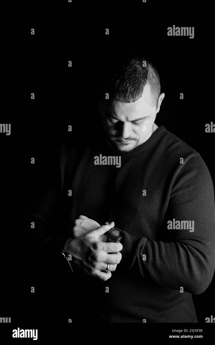 Introspective Man Checking His Watch in Low-Key Portrait Stock Photo ...