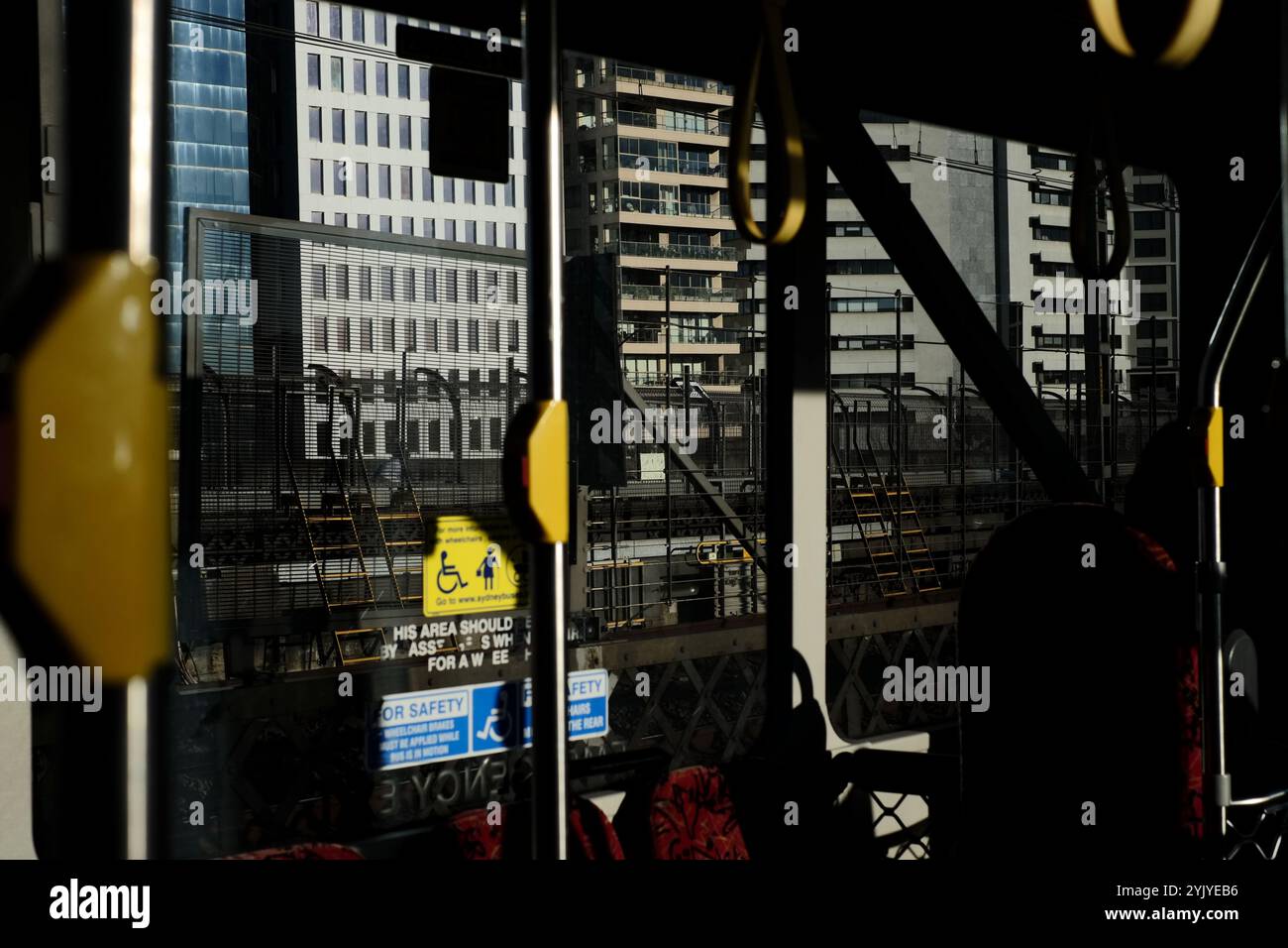 An array of office building windows behind a mesh of fencing and iron ...