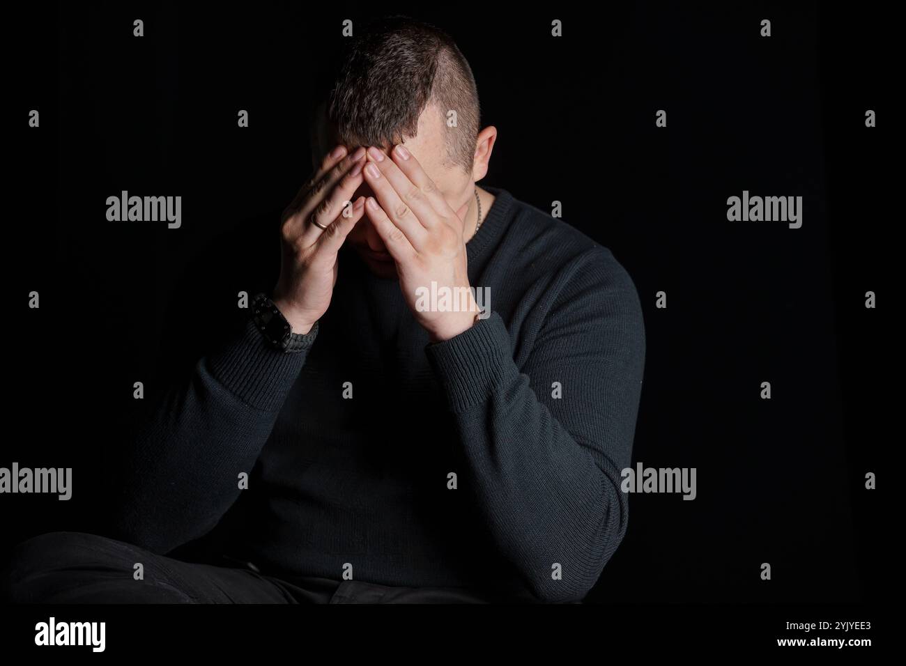 Emotional Struggle: A Moment of Despair in a Dark Setting Stock Photo ...