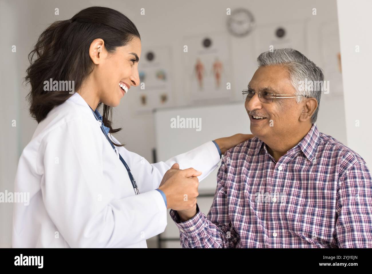 Cardiologist touch shoulder holding hand of older patient Stock Photo ...