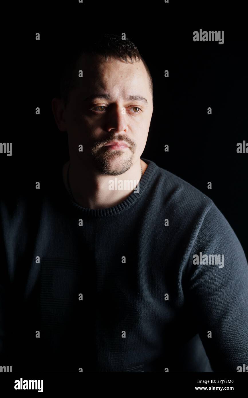 Introspective Man in Low Light Portrait Stock Photo - Alamy