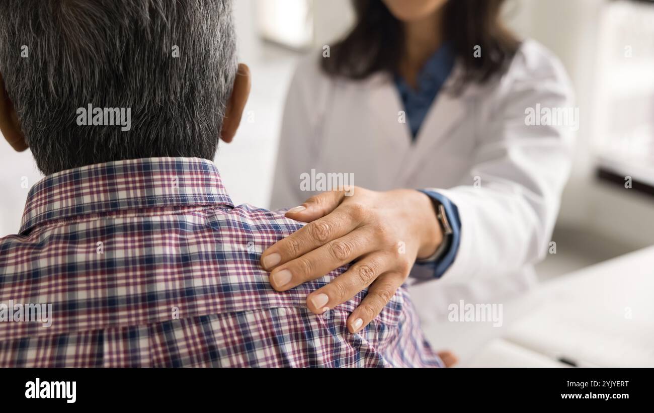 Doctor touch shoulder of aged male patient Stock Photo - Alamy