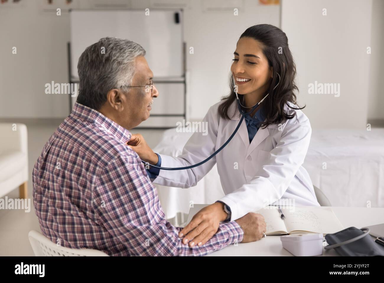 Cardiologist check heart rate of older male patient with stethoscope ...