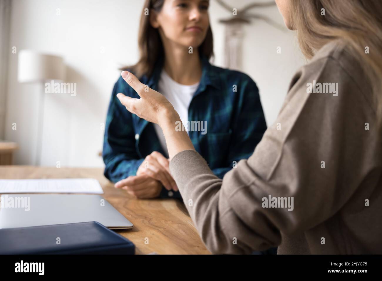 Closeup shot two women lead dialogue seated at workplace table Stock ...