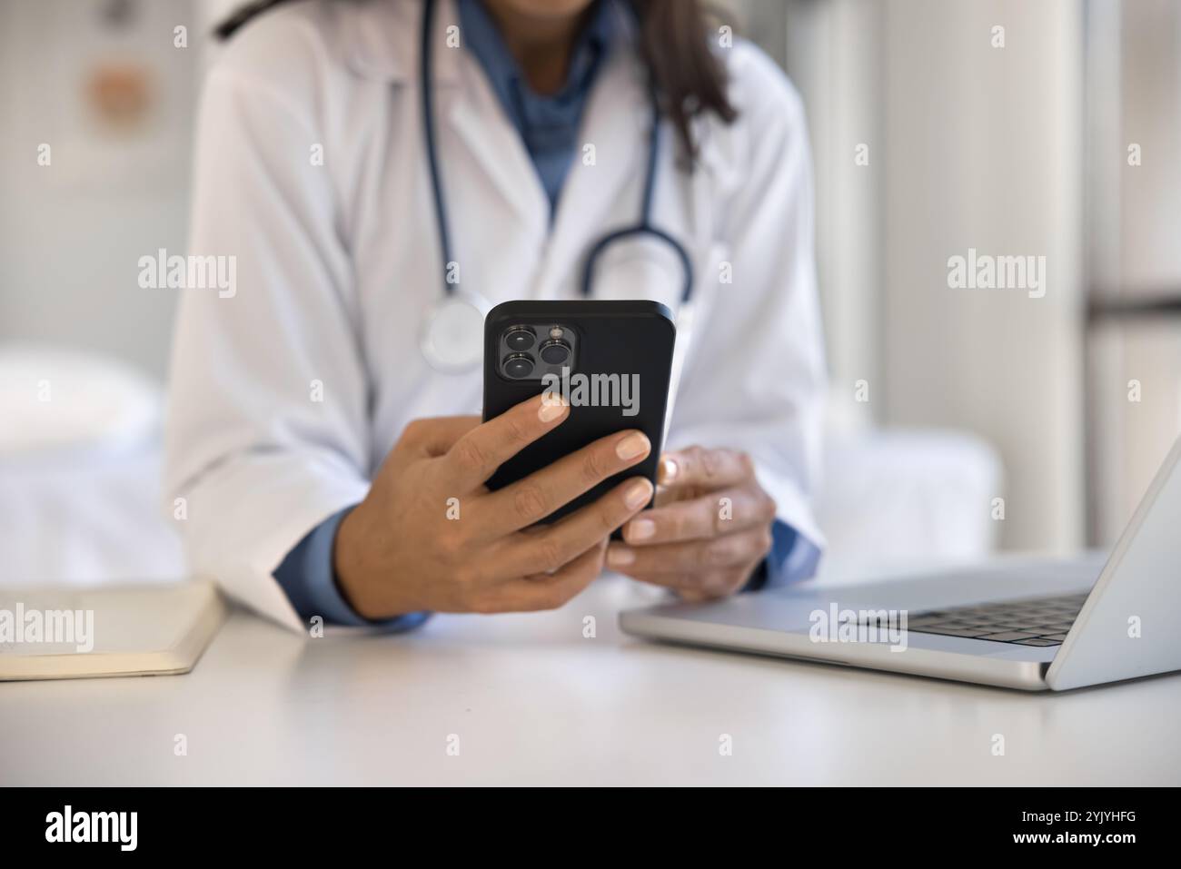 Close up female doctor using modern smartphone at workplace Stock Photo ...
