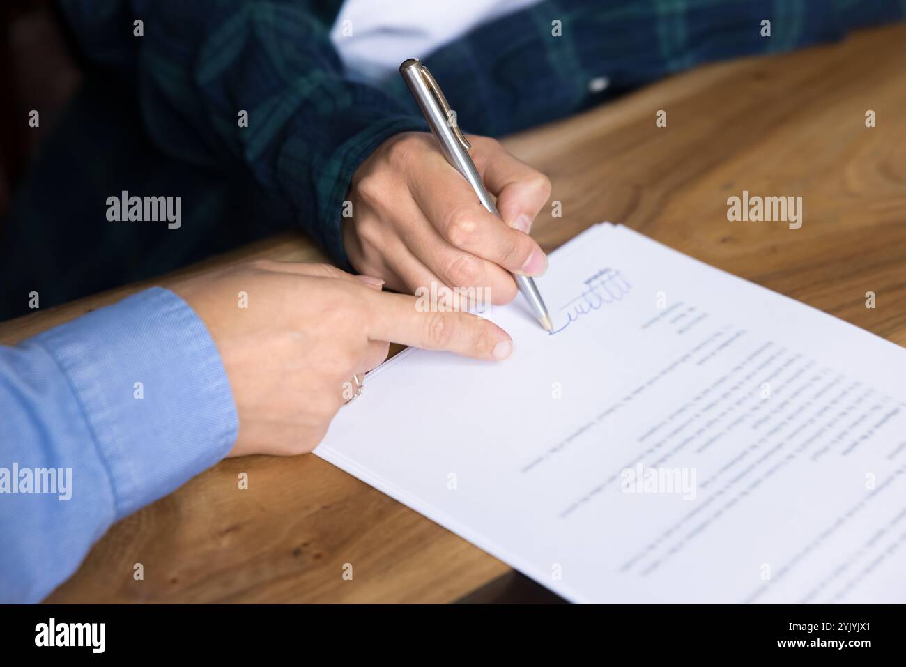 Client signing formal document during meeting in office, closeup Stock ...