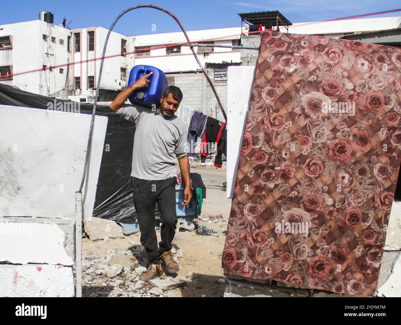 Gaza City. 15th Nov, 2024. Displaced Palestinian Saed Ghanim carries ...