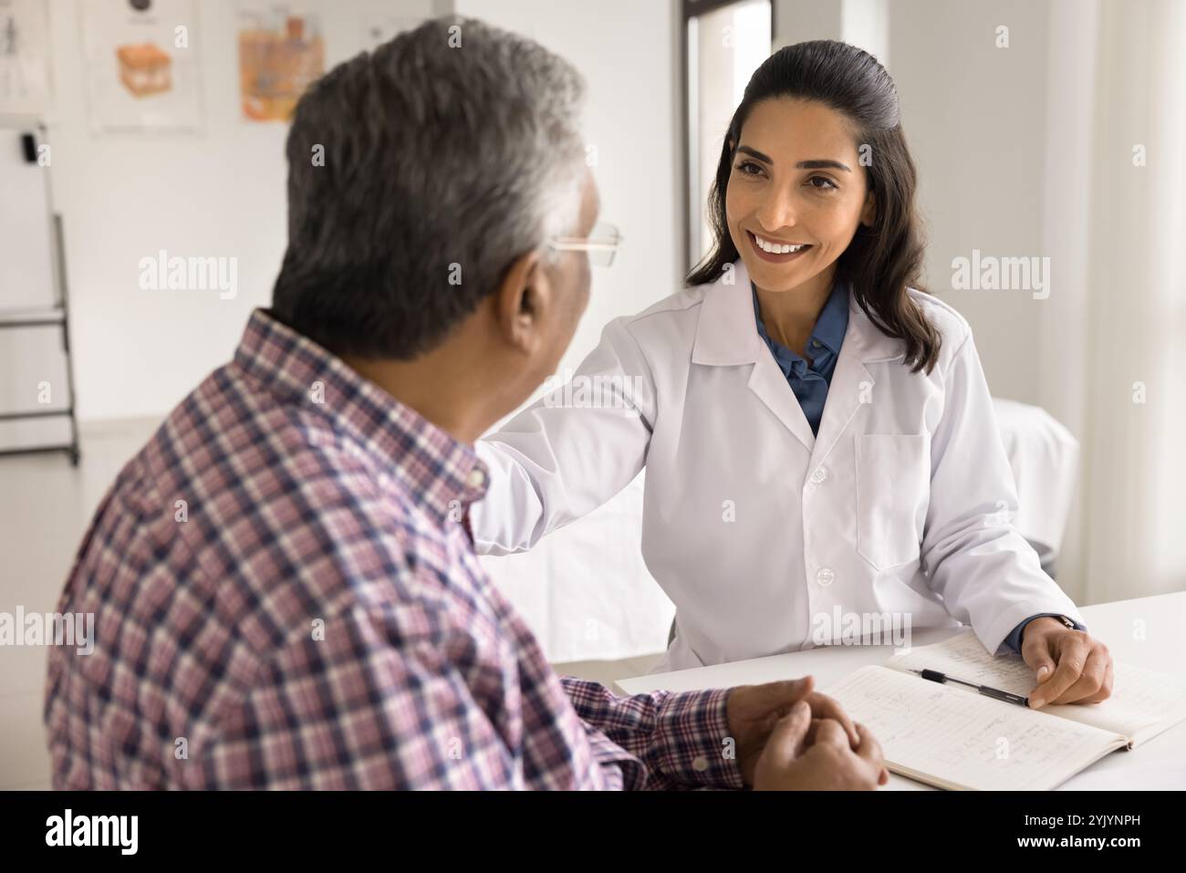 Female therapist touch shoulder of older male patient during talk Stock ...