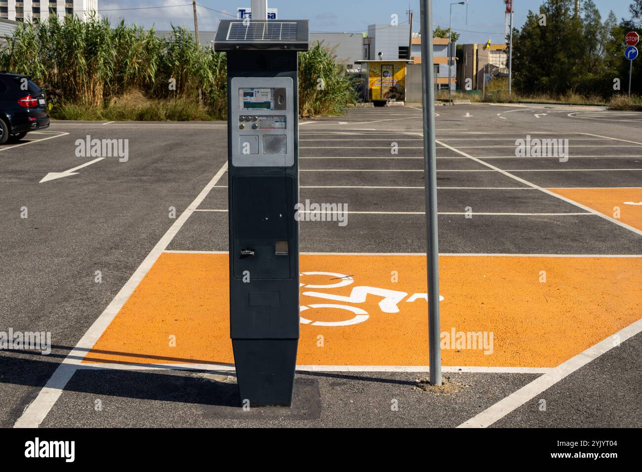 Parking meter with solar panel standing in a reserved parking space for ...