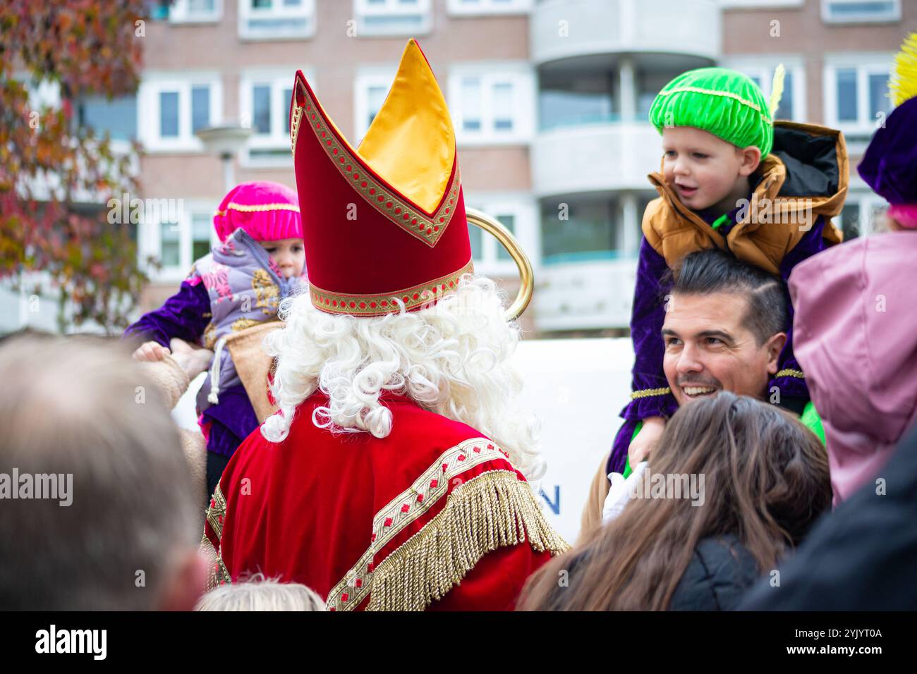 Saint Nicholas (Dutch: Sinterklaas) talks with a child during his ...