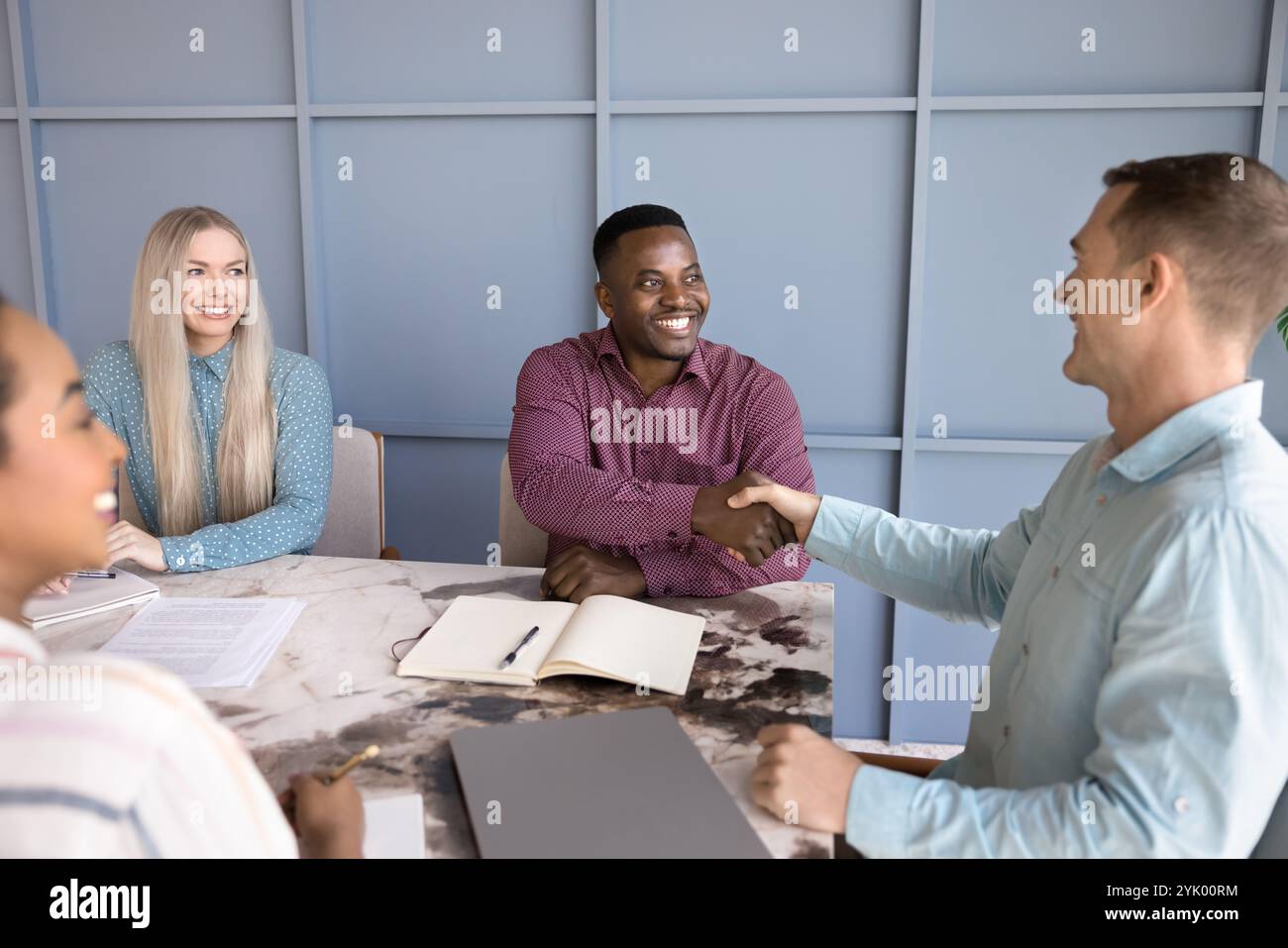 Proud successful ambitious African project manager shaking hands with ...
