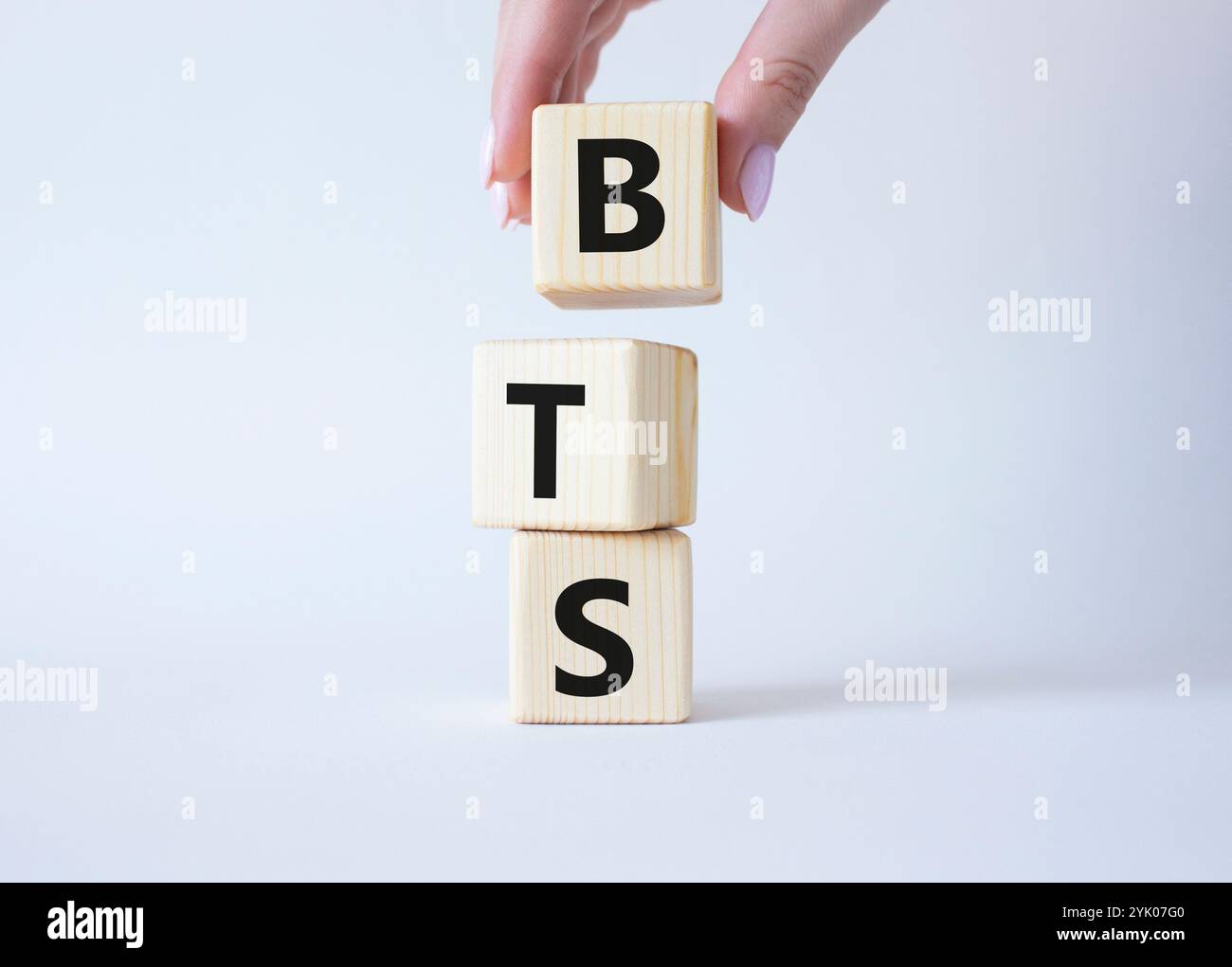 BTS symbol. Wooden cubes with word BTS. Businessman hand Beautiful ...